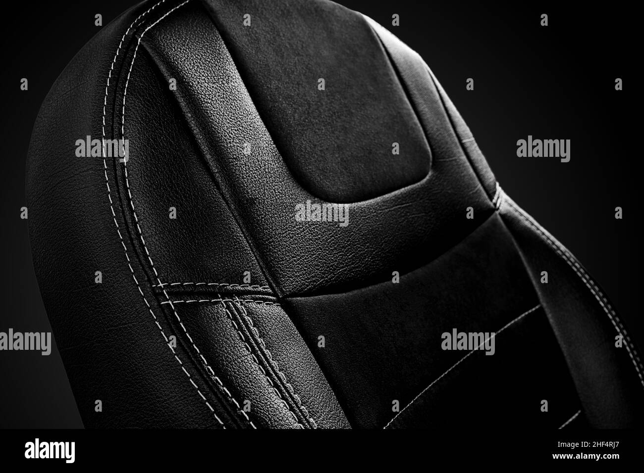 Closeup of ergonomic black backrest of passenger car seat on dark ...