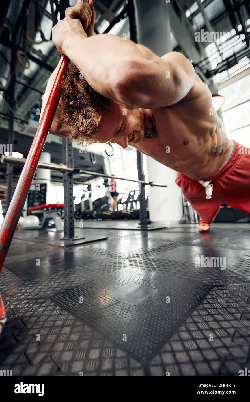 Strength concept. Male athlete using hammer during fitness workout ...
