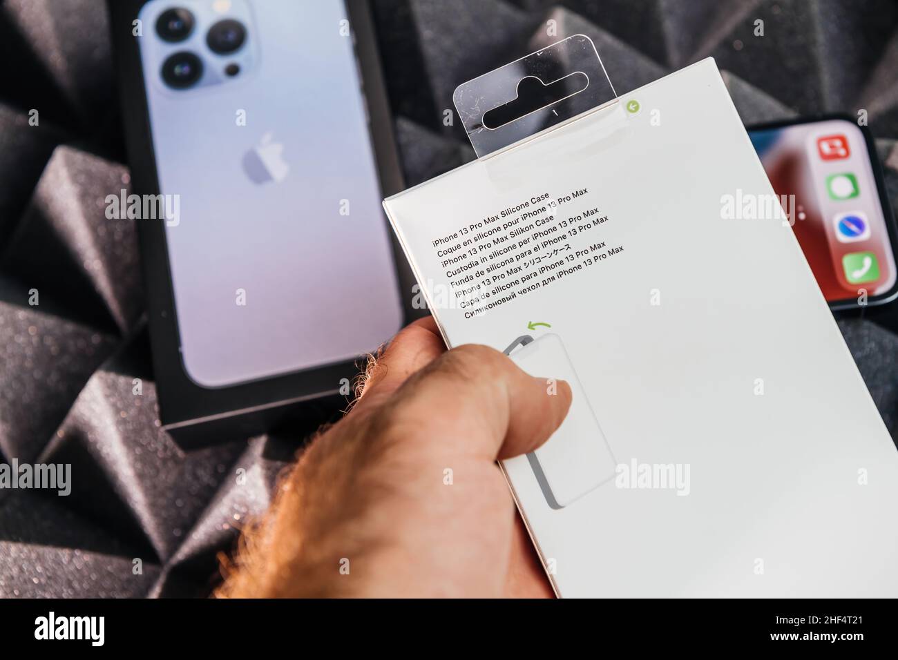 Paris, France - Sep 25, 2021: POV male hand holding orange iPhone 13 ...