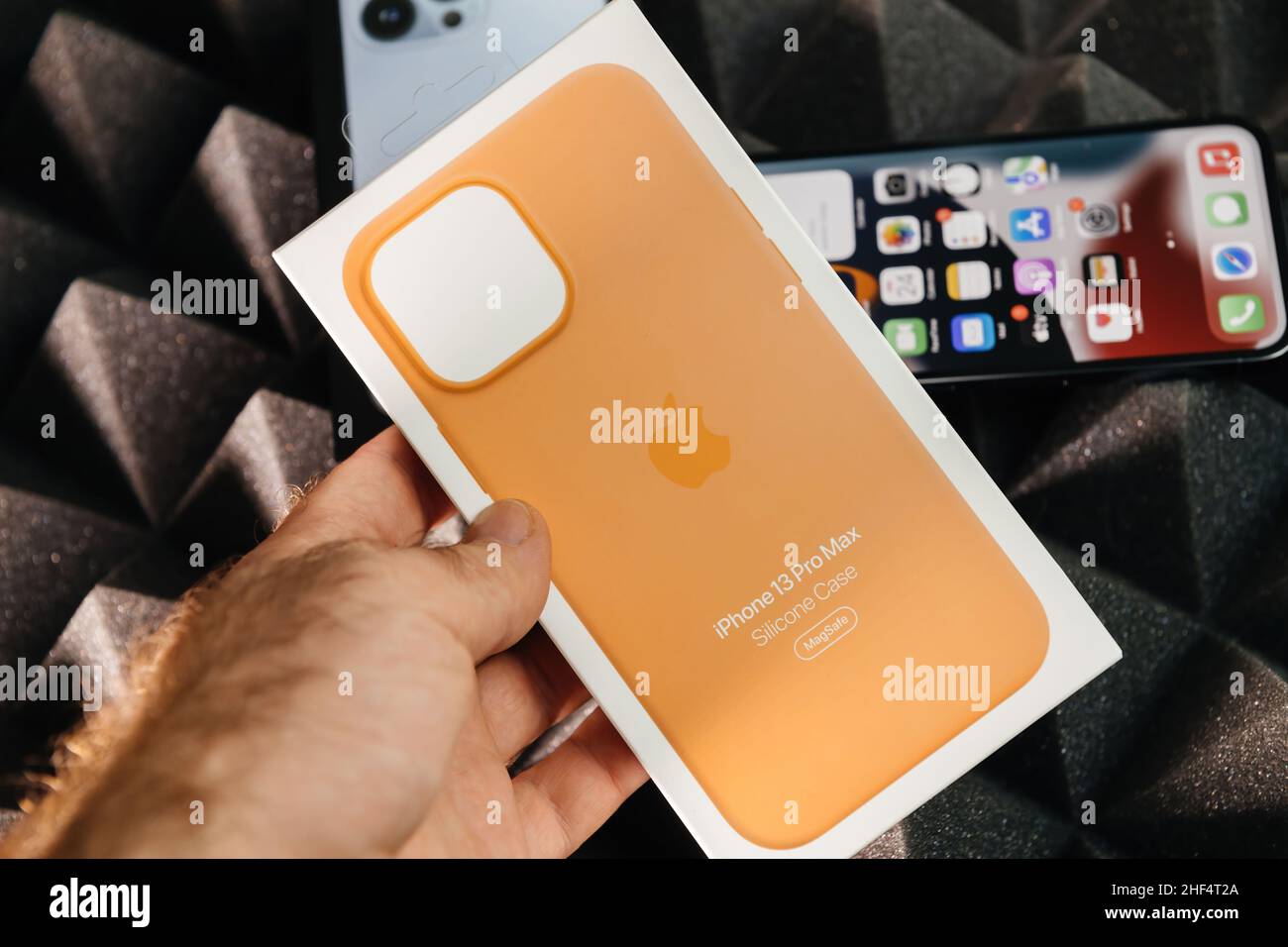 Paris, France - Sep 25, 2021: POV male hand holding orange iPhone 13 ...