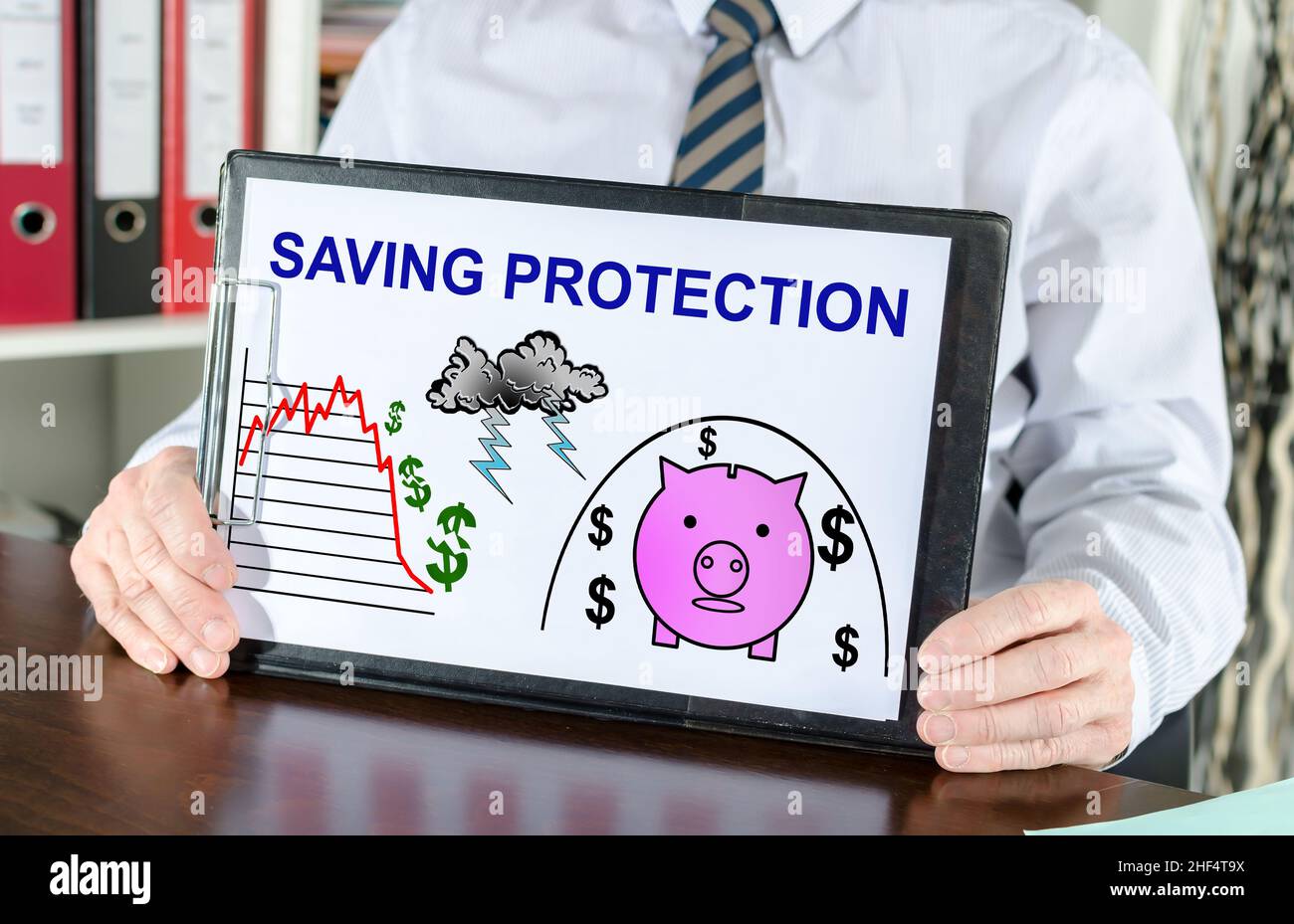 Saving protection concept shown by a businessman Stock Photo - Alamy