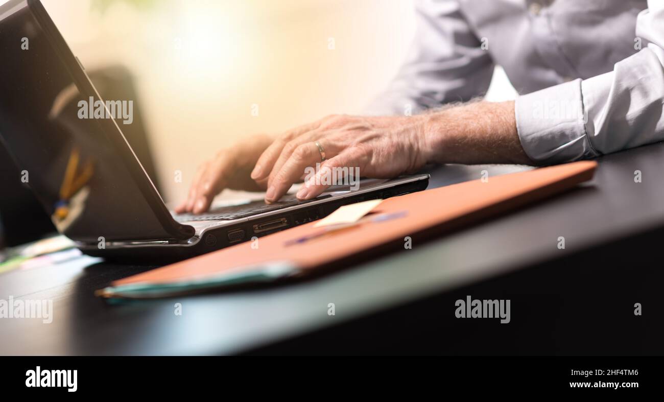 Hands typing on a laptop, light effect Stock Photo - Alamy