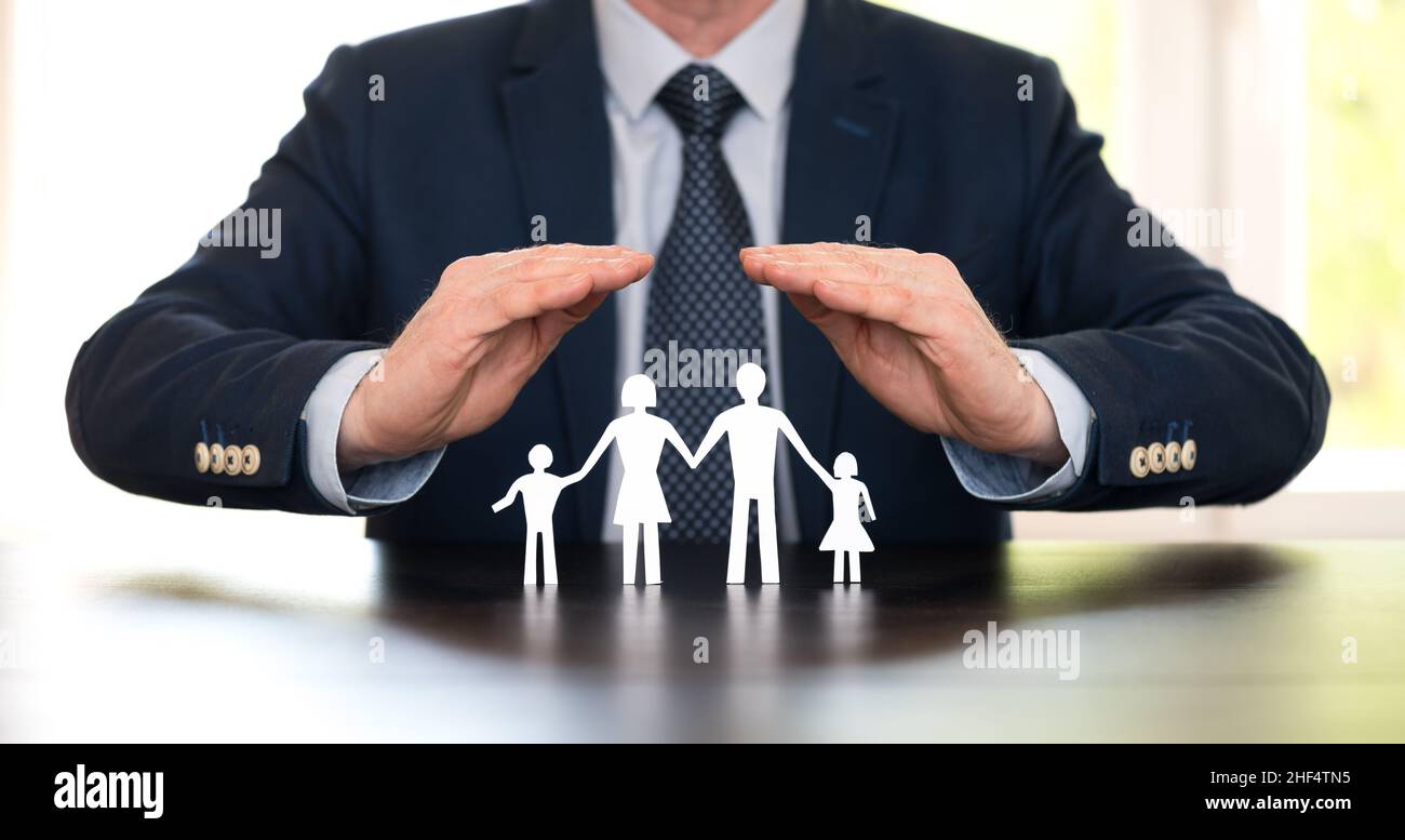 Insurer protecting a family with his hands Stock Photo - Alamy