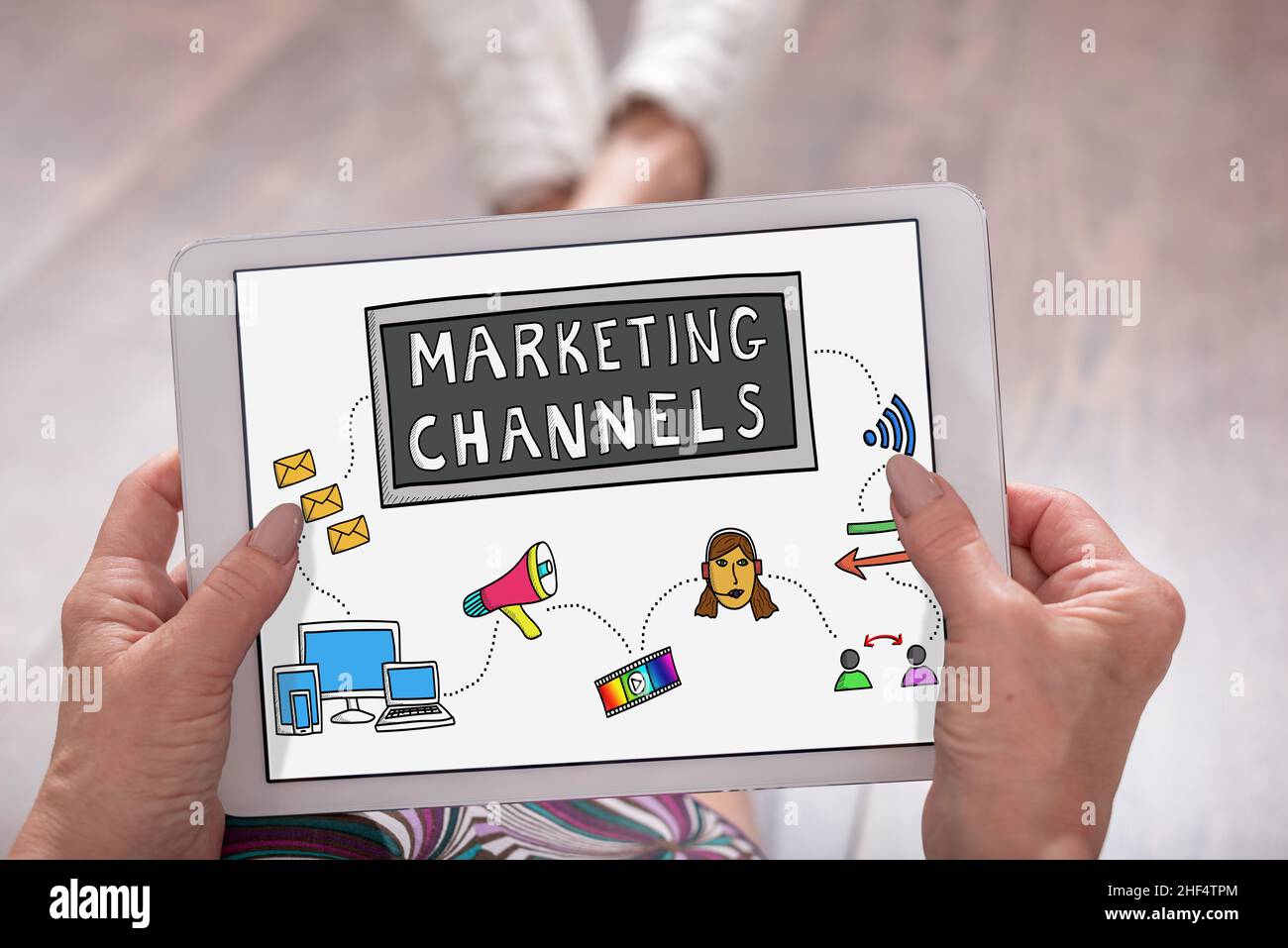 Marketing channels concept shown on a tablet held by a woman Stock ...