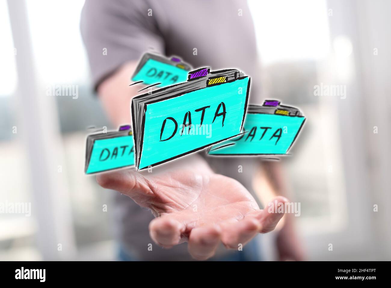 Data concept above the hand of a man in background Stock Photo - Alamy