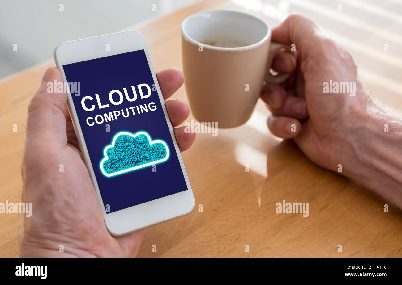 Male hands holding a smartphone with cloud computing concept and a cup of coffee Stock Photo - Alamy