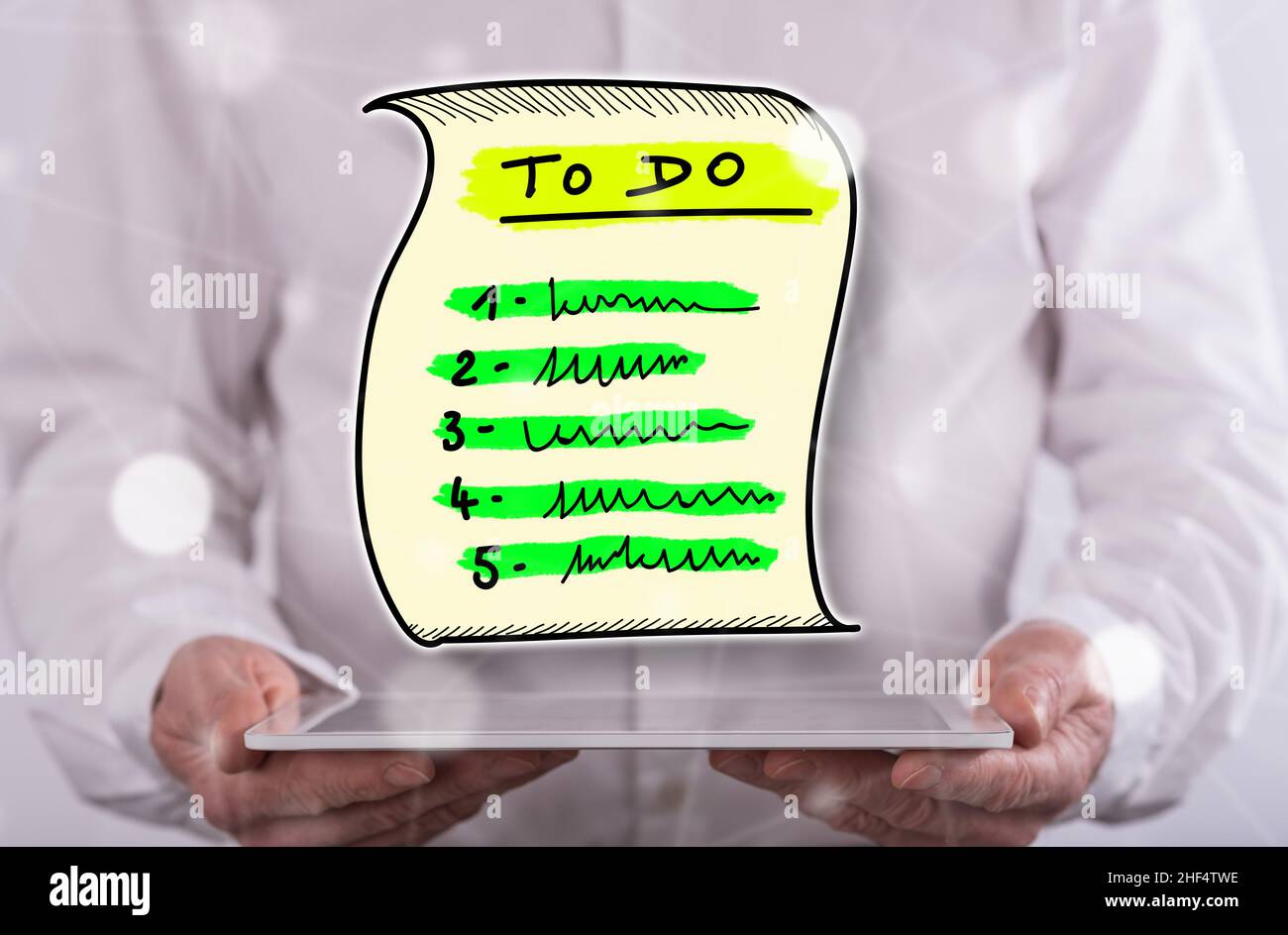 To do list concept above a tablet held by a man in background Stock ...