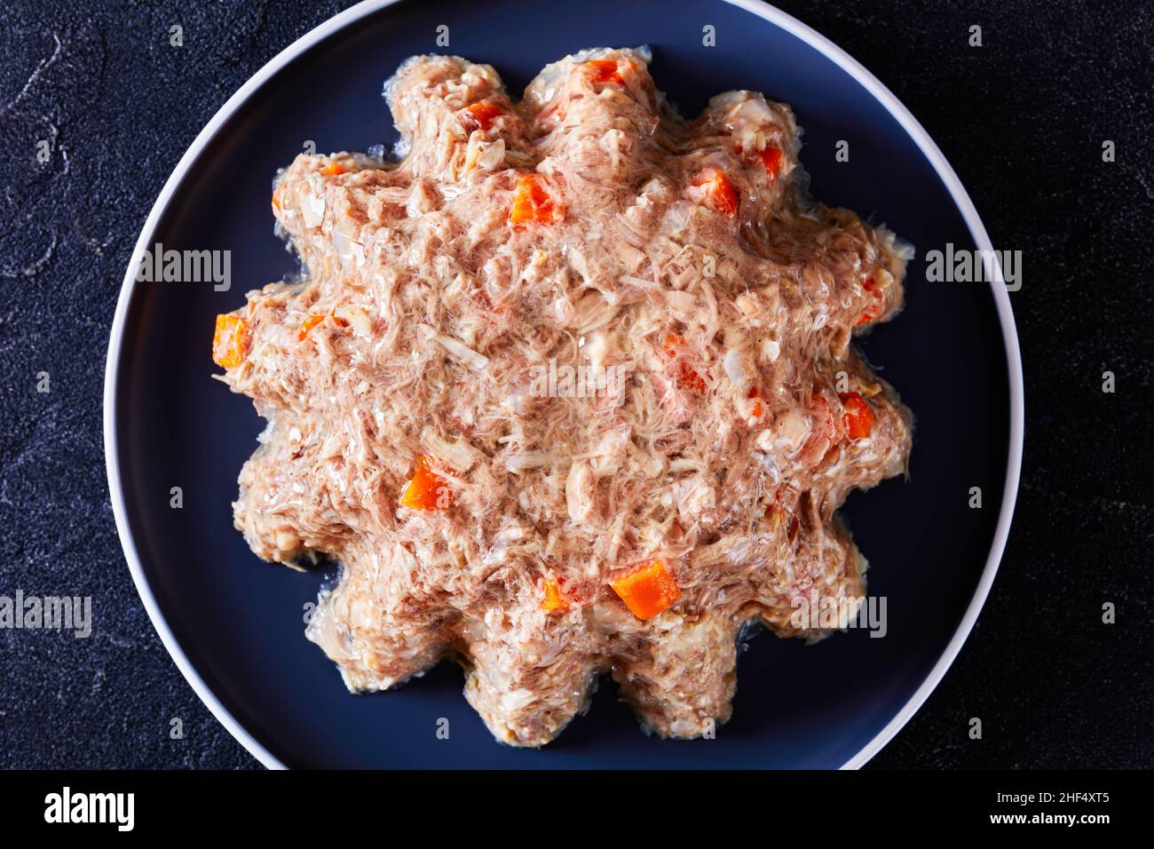 meat aspic, jellied slow cooked meat on a plate on a concrete table ...
