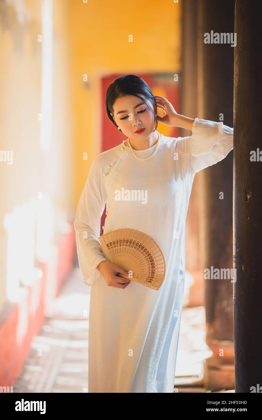 Ho Chi Minh City, Vietnam: Portrait women in white ao dai Vietnam, The Ao dai ( long-dress ...