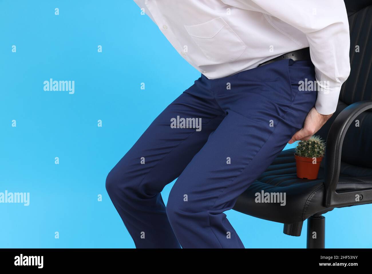 Man sit down on a chair with a cactus. Hemorrhoids concept Stock Photo ...