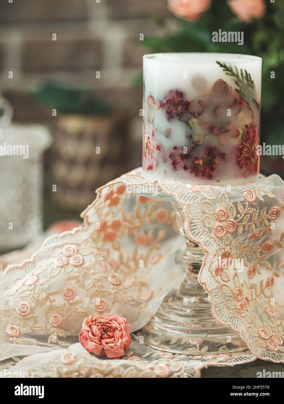 Handmade candles of a unique design, with different flowers, dry leaves ...