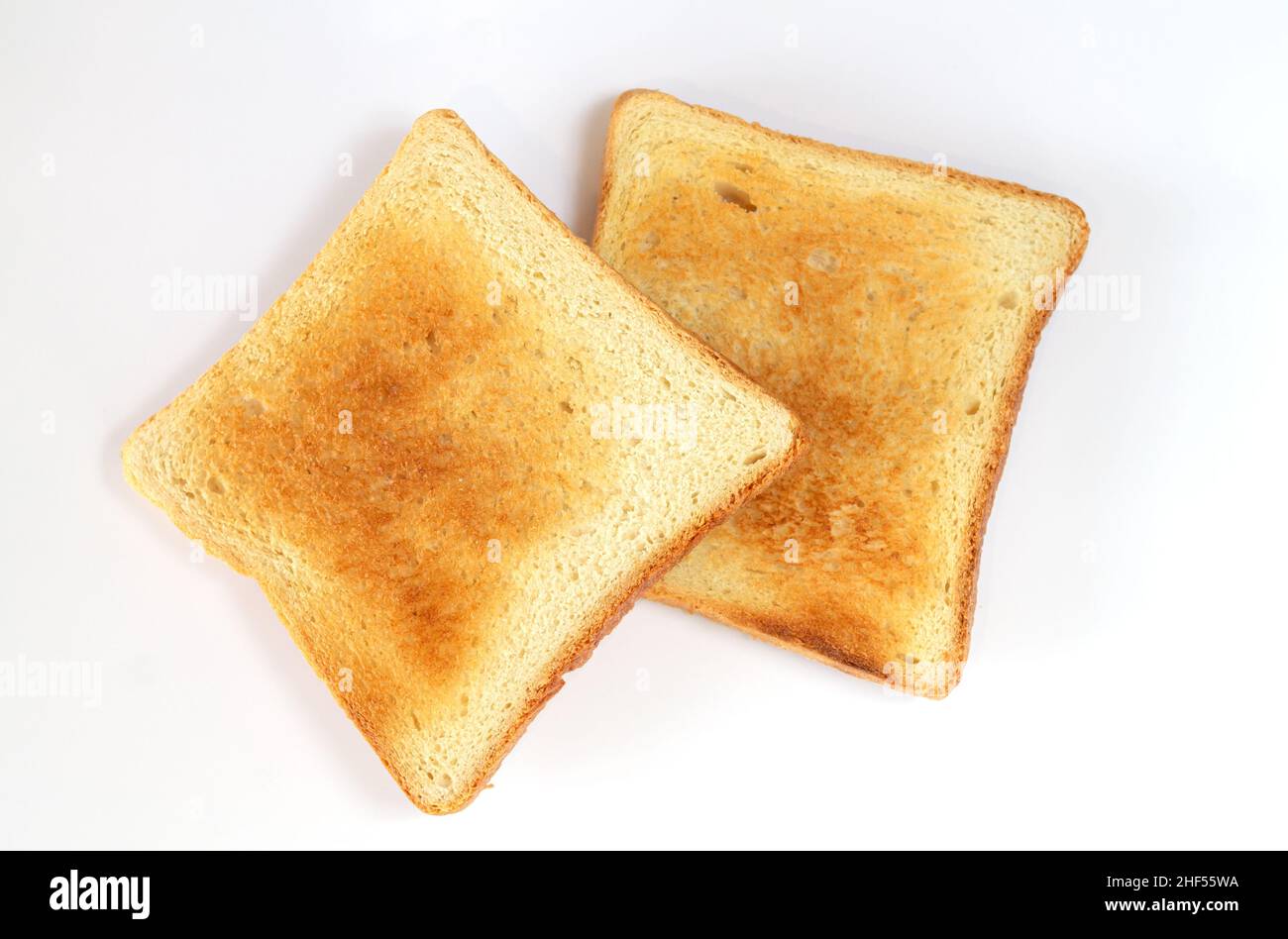 Two slices of hot toasted bread isolated on white, top view Stock Photo ...