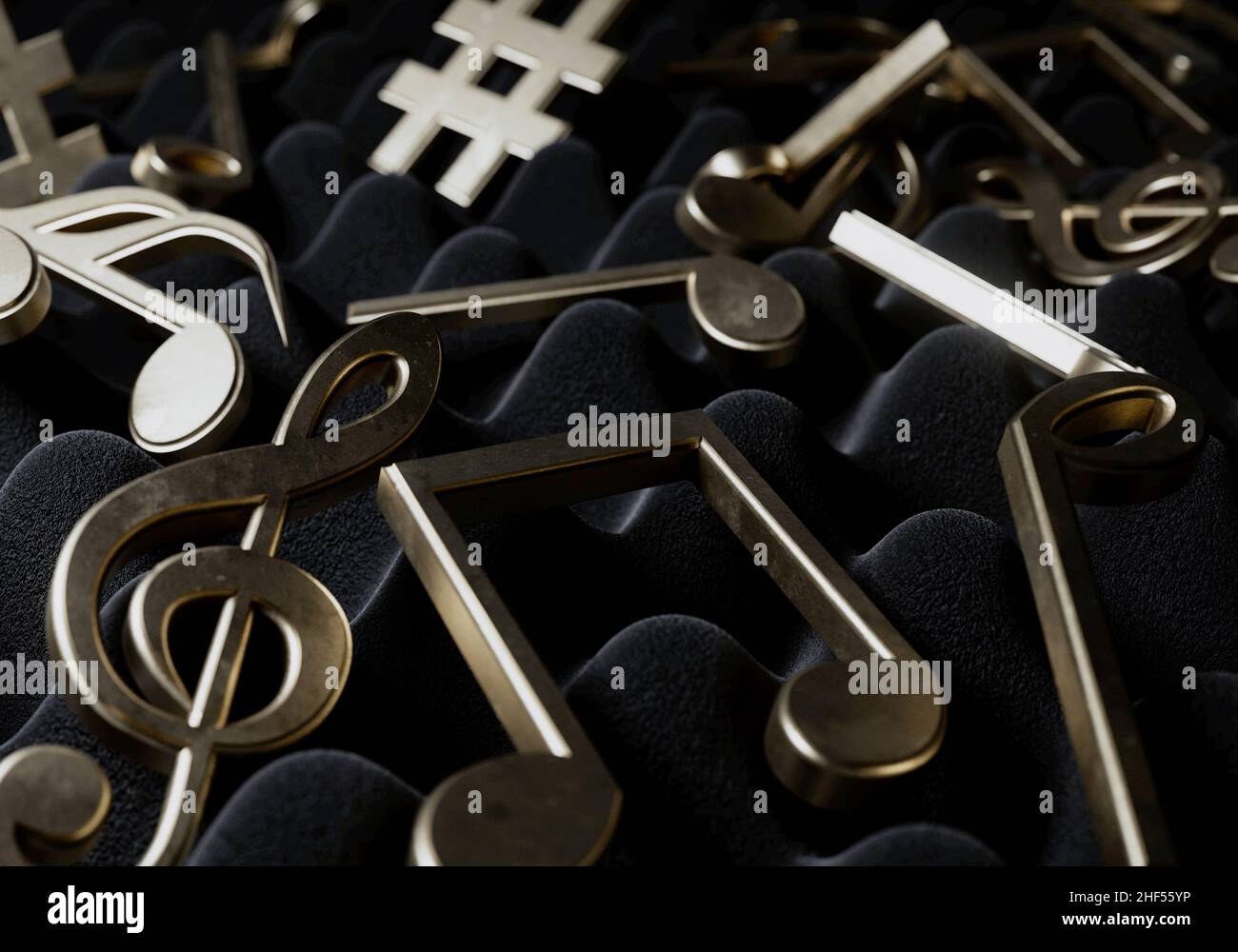 A concept showing a section of grey sound foam with gold music symbols ...