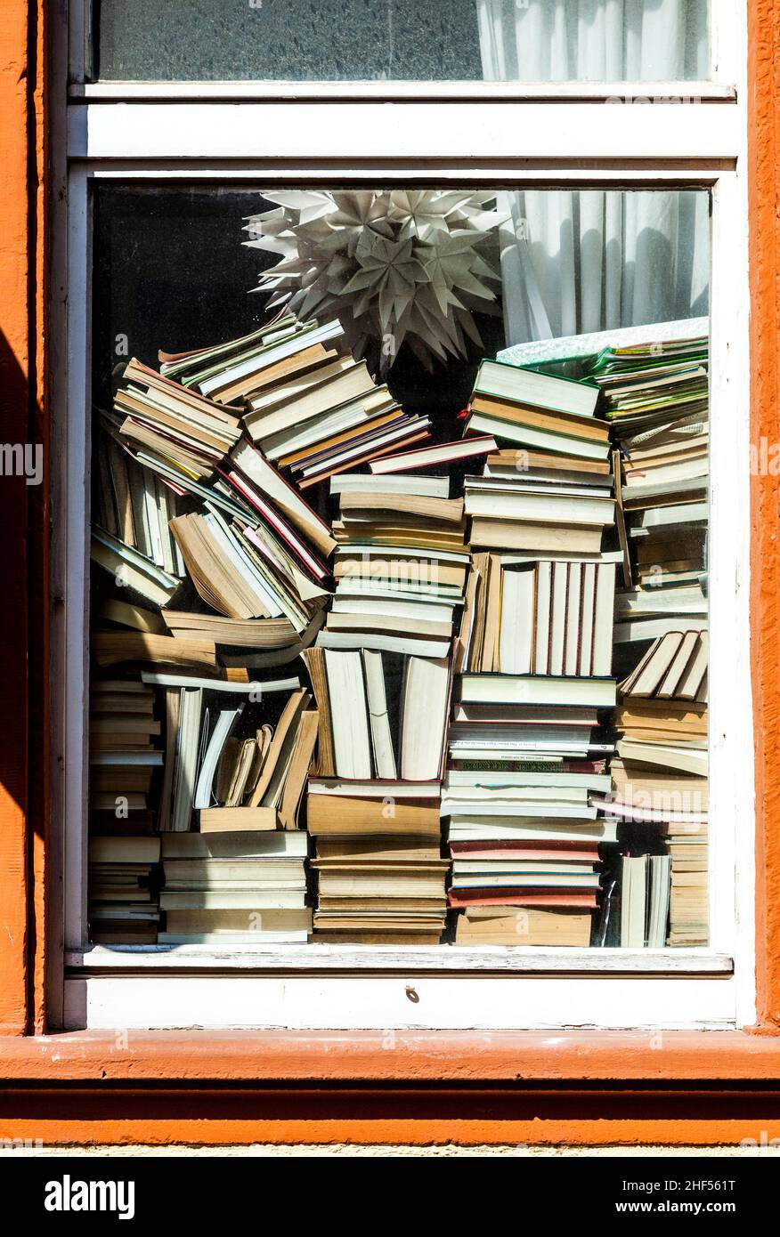 many books stapled in front of a window Stock Photo - Alamy