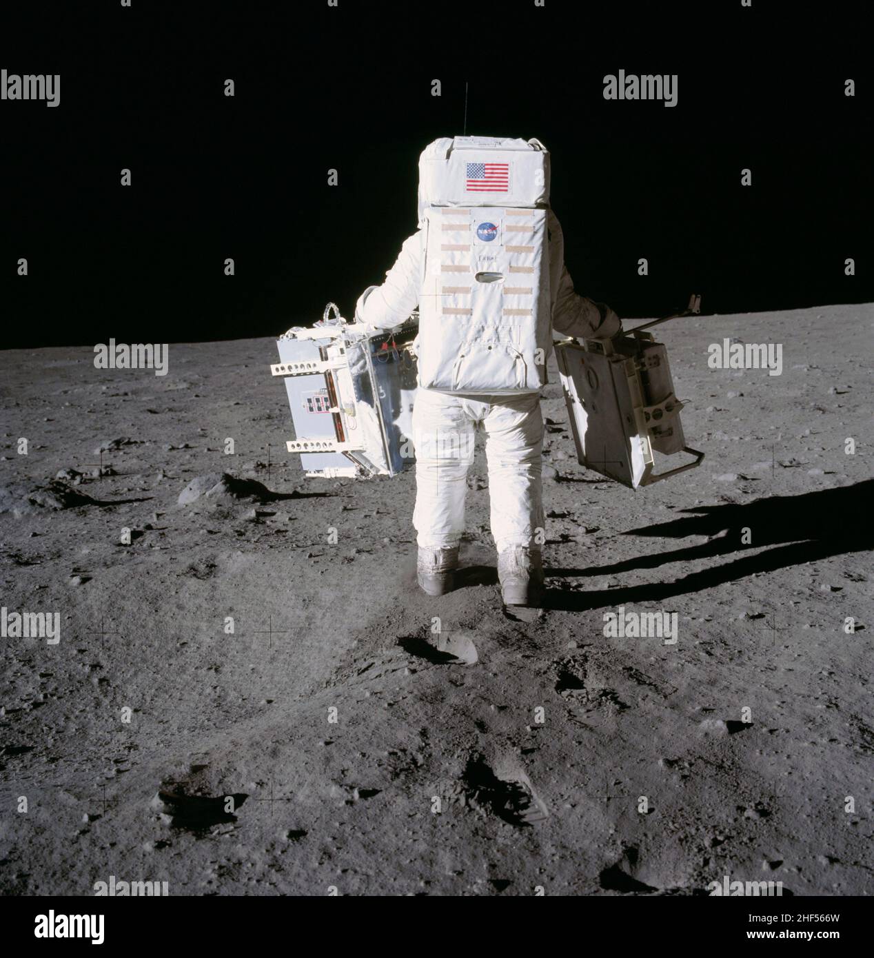 Astronaut Edwin Aldrin prepares to deploy two components of the Early ...