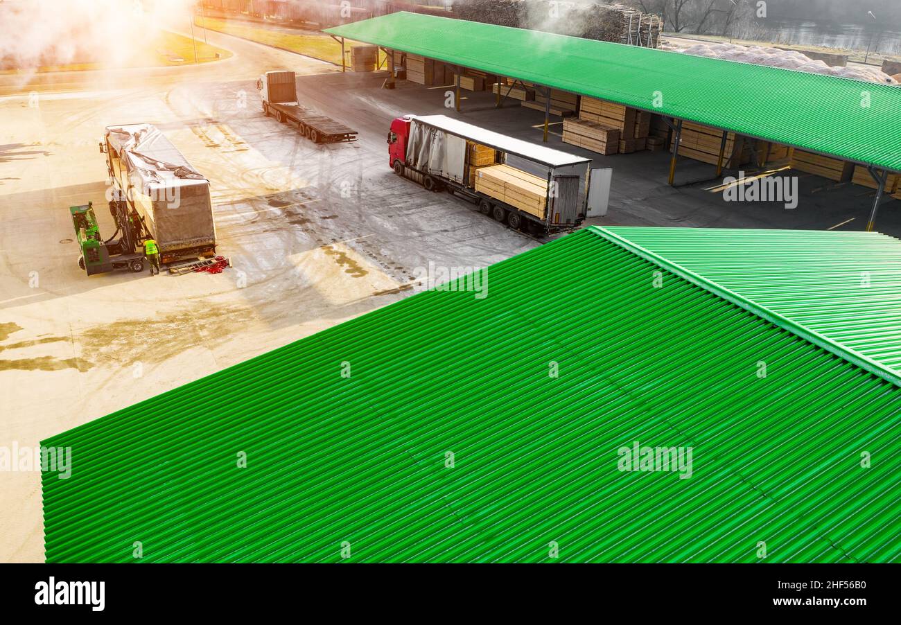 trucks in the finished goods warehouse are loaded with boards top view ...