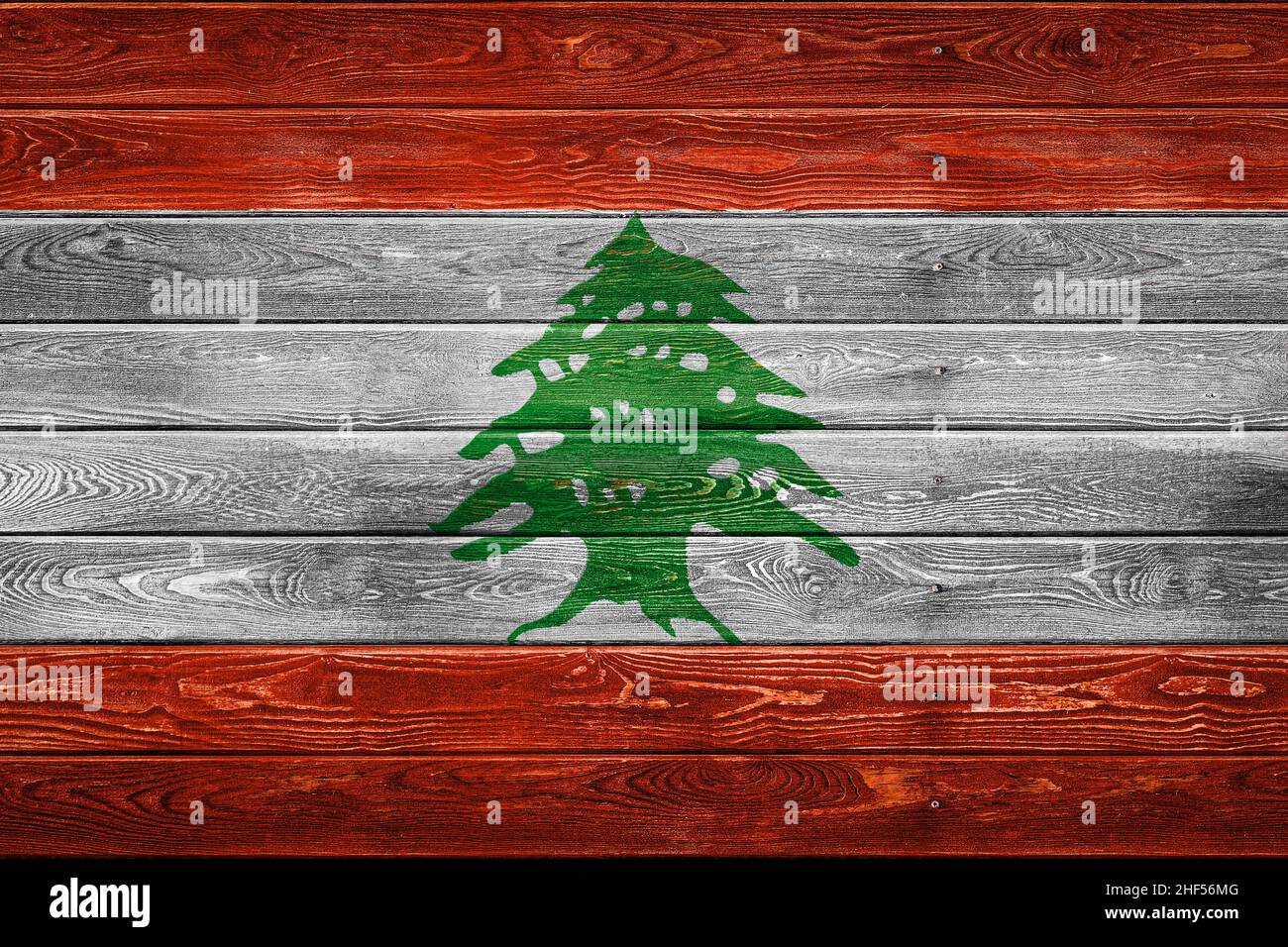 The national flag of Lebanon is painted on a camp of even boards nailed ...