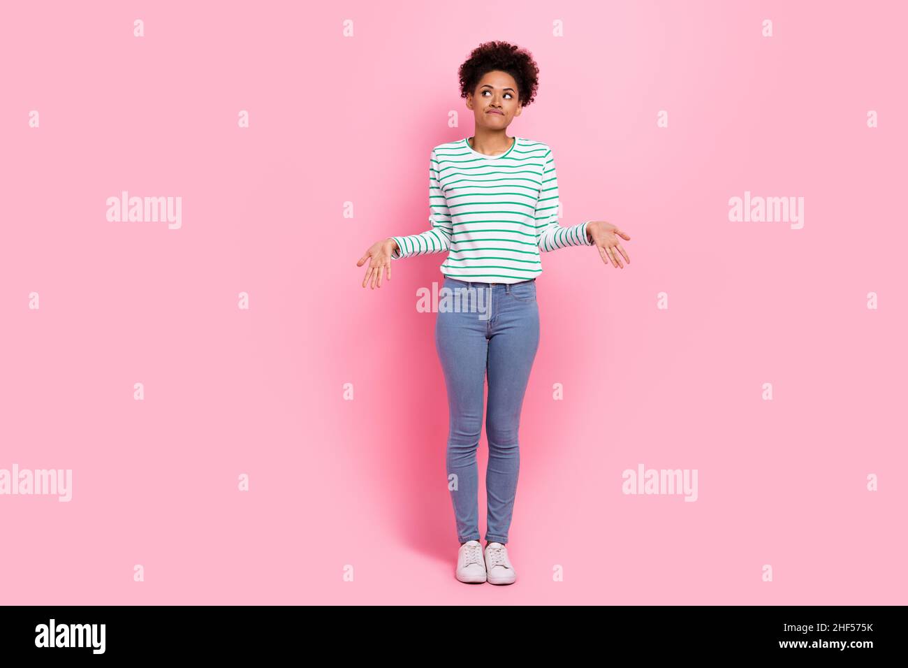 Full body photo of unsure curly hairstyle young lady look empty space ...