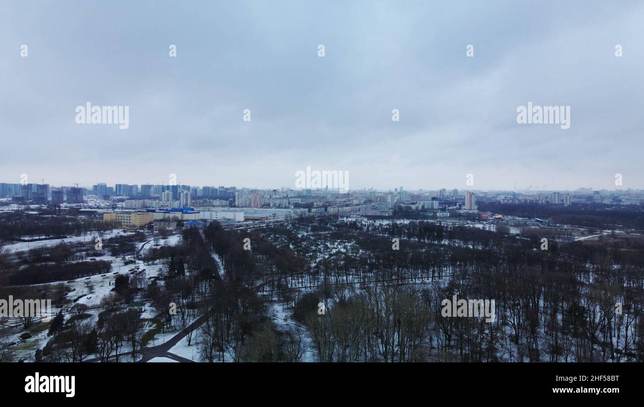 Flying in a suburban park. City blocks are visible. Winter cityscape ...