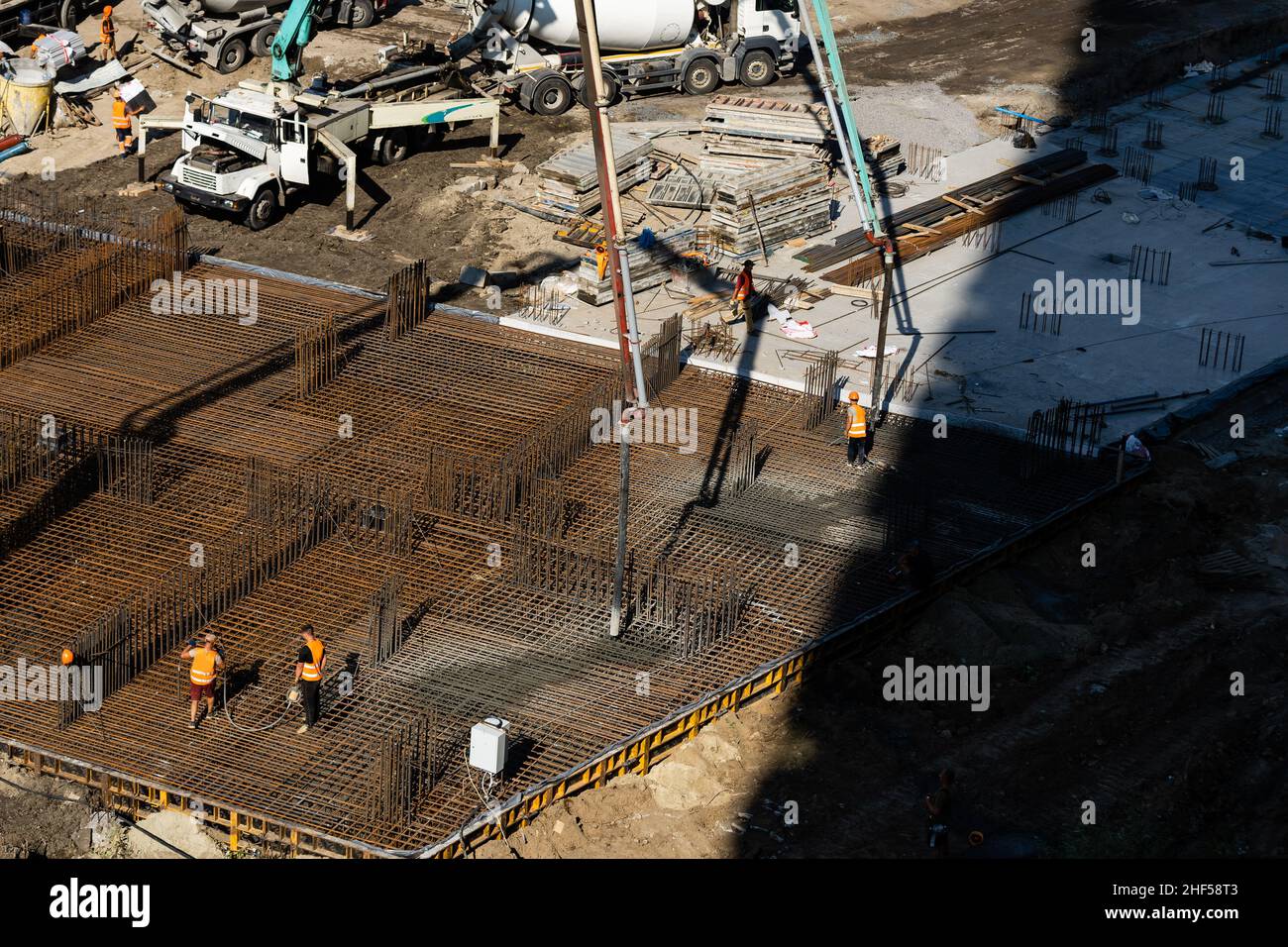 Huge construction site with a lot of construction equipment, houses ...