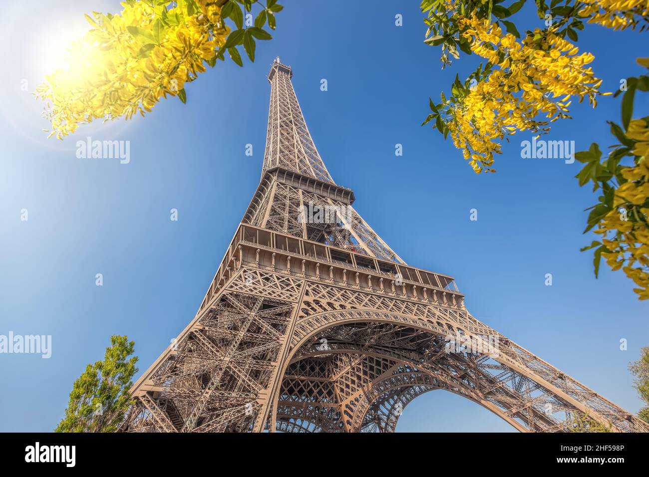 Eiffel Tower with spring trees against blue sky in Paris, France Stock ...