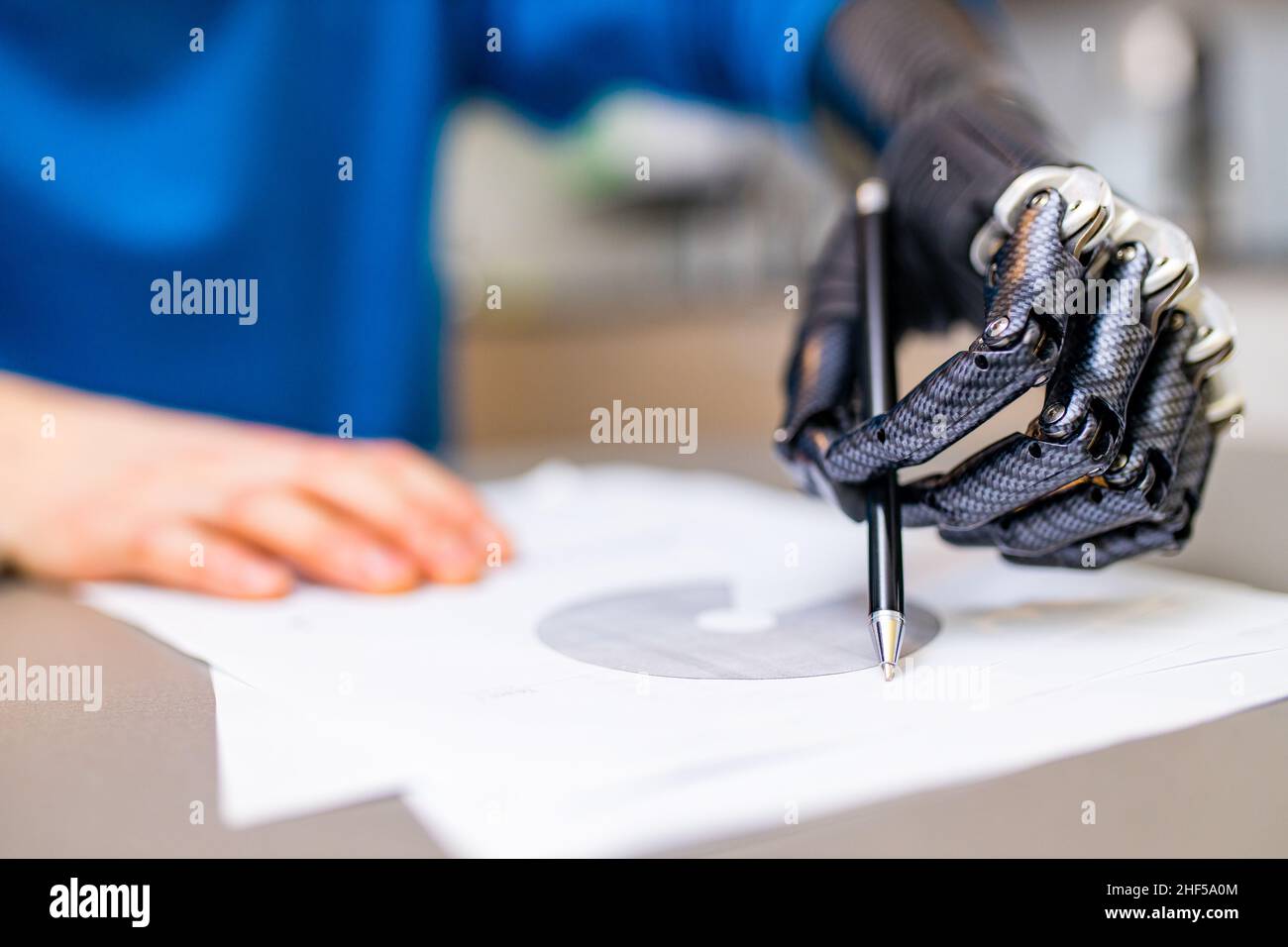 man with prosthetic hand writing development at home Stock Photo - Alamy
