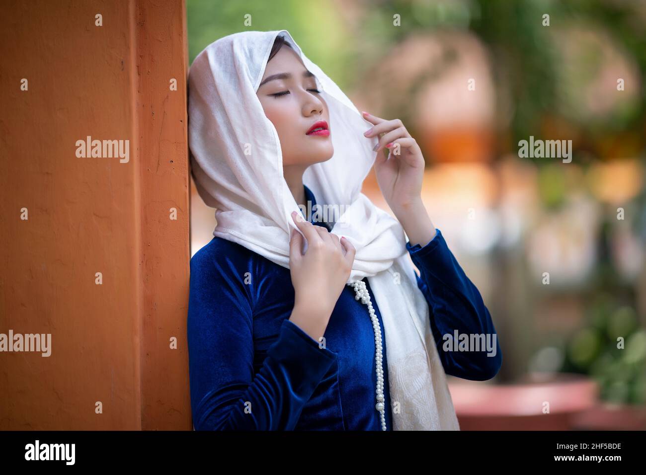 Ho Chi Minh city, Viet Nam: Vietnamese girl going to pagoda in ao dai ...
