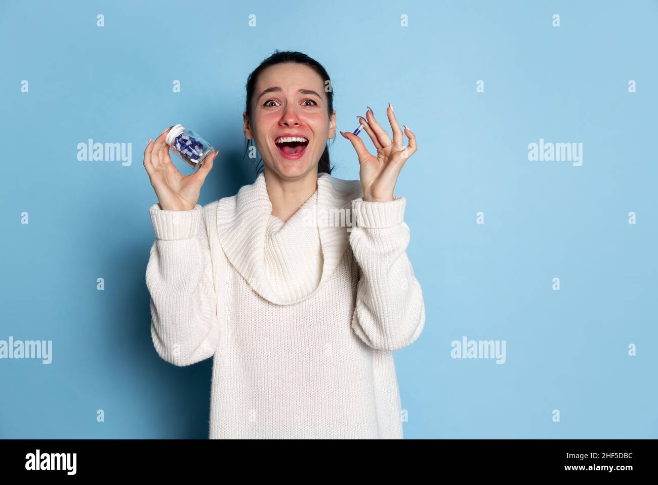Shocked young Caucasian girl feeling sick isolated over blue background ...