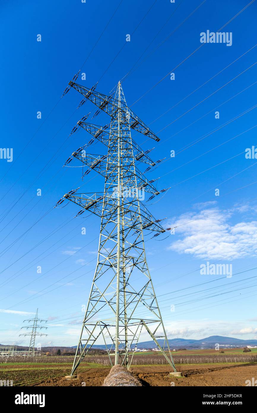 High voltage pylons tower under blue sky Stock Photo - Alamy