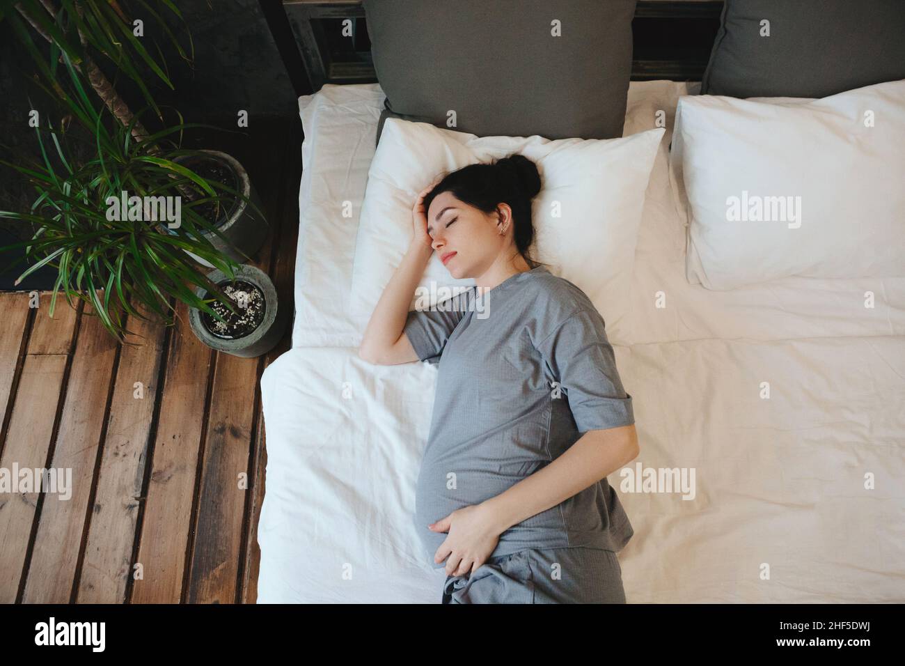 View from above of pregnant woman relaxing resting on couch at home ...