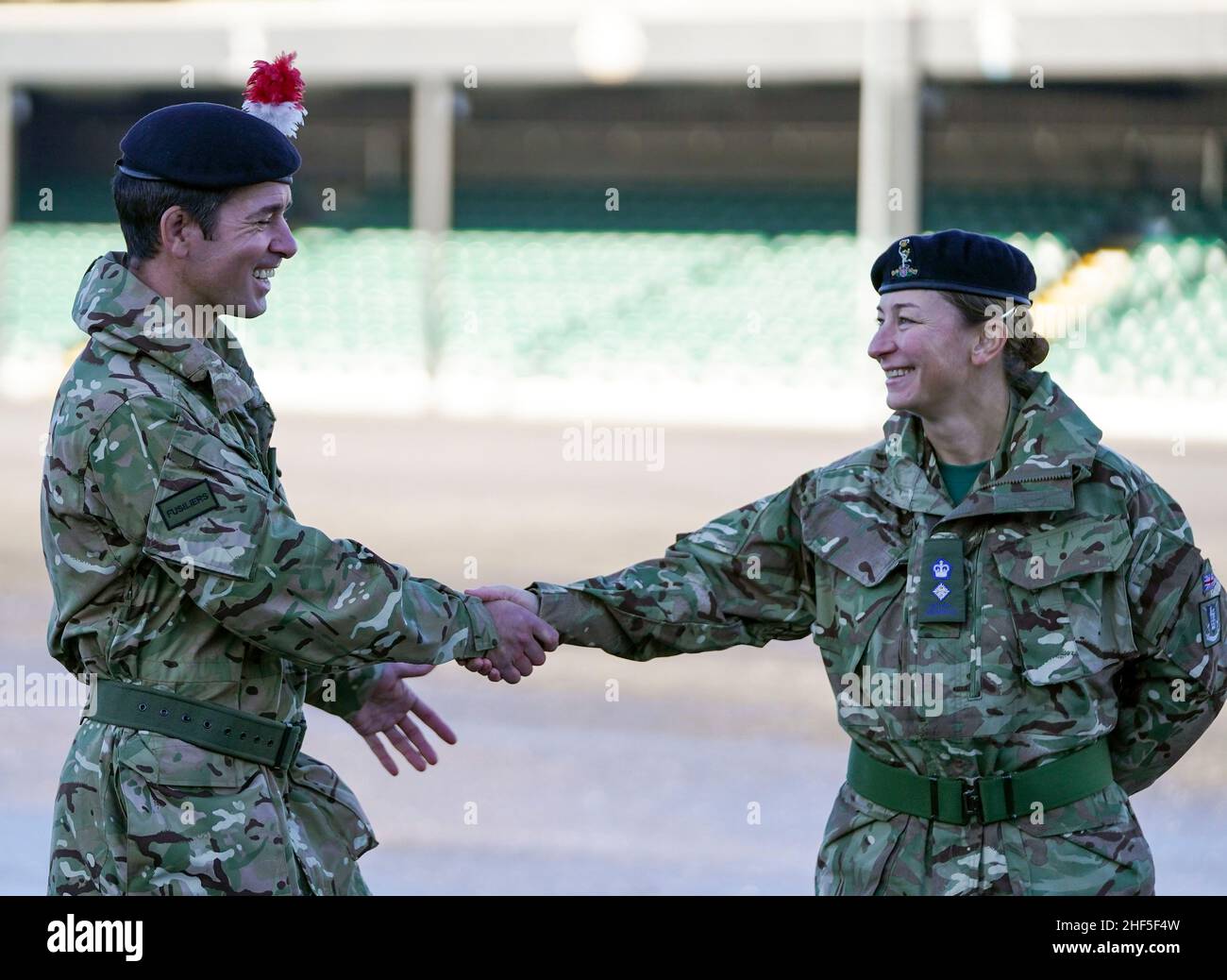 Lt Col Shamus Kelly shakes the hand of his wife, Lt Col Lyndsey Kelly ...