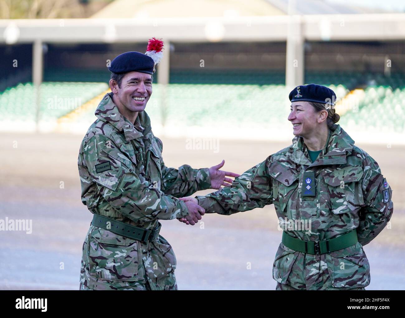 Lt Col Shamus Kelly shakes the hand of his wife, Lt Col Lyndsey Kelly ...