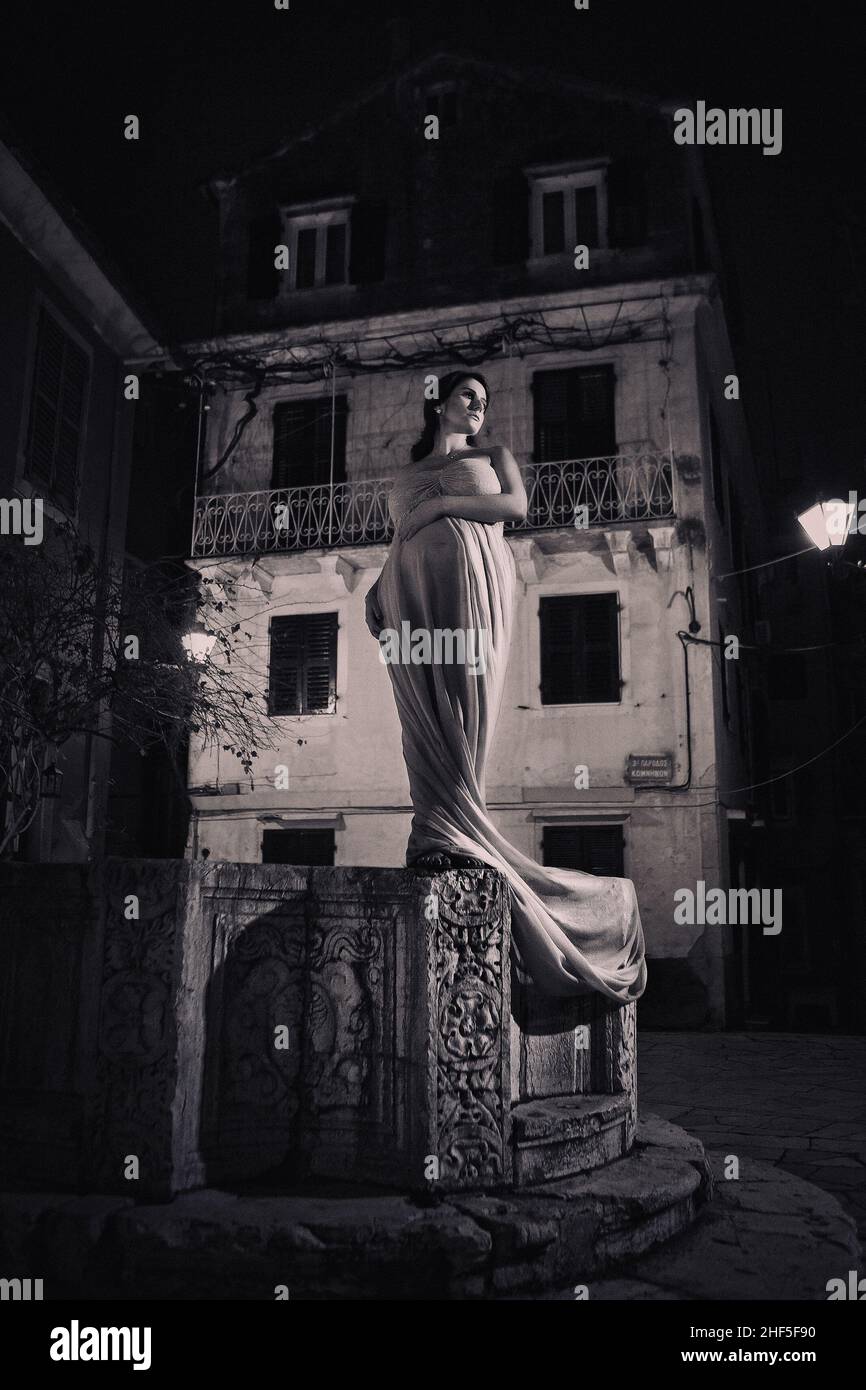 Young pregnant woman standing like a statue at night Stock Photo - Alamy