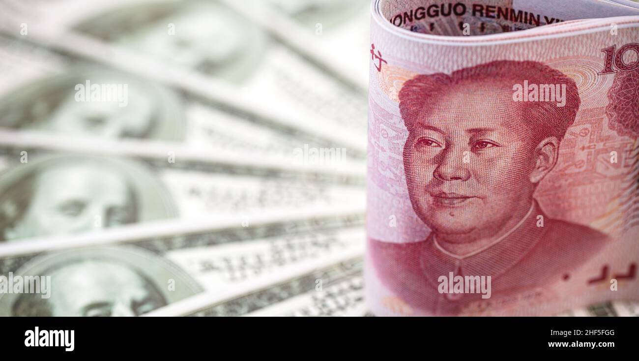 100 dollar banknotes with one hundred yuan banknote (Renminbi), concept ...