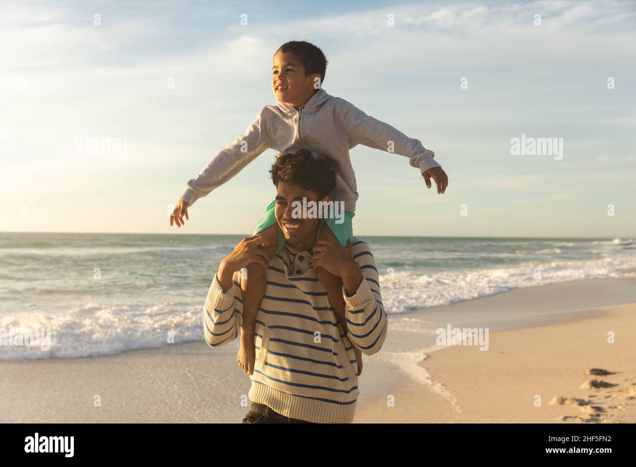 Father carrying little daughter on his shoulders on the beach hi-res stock photography and ...