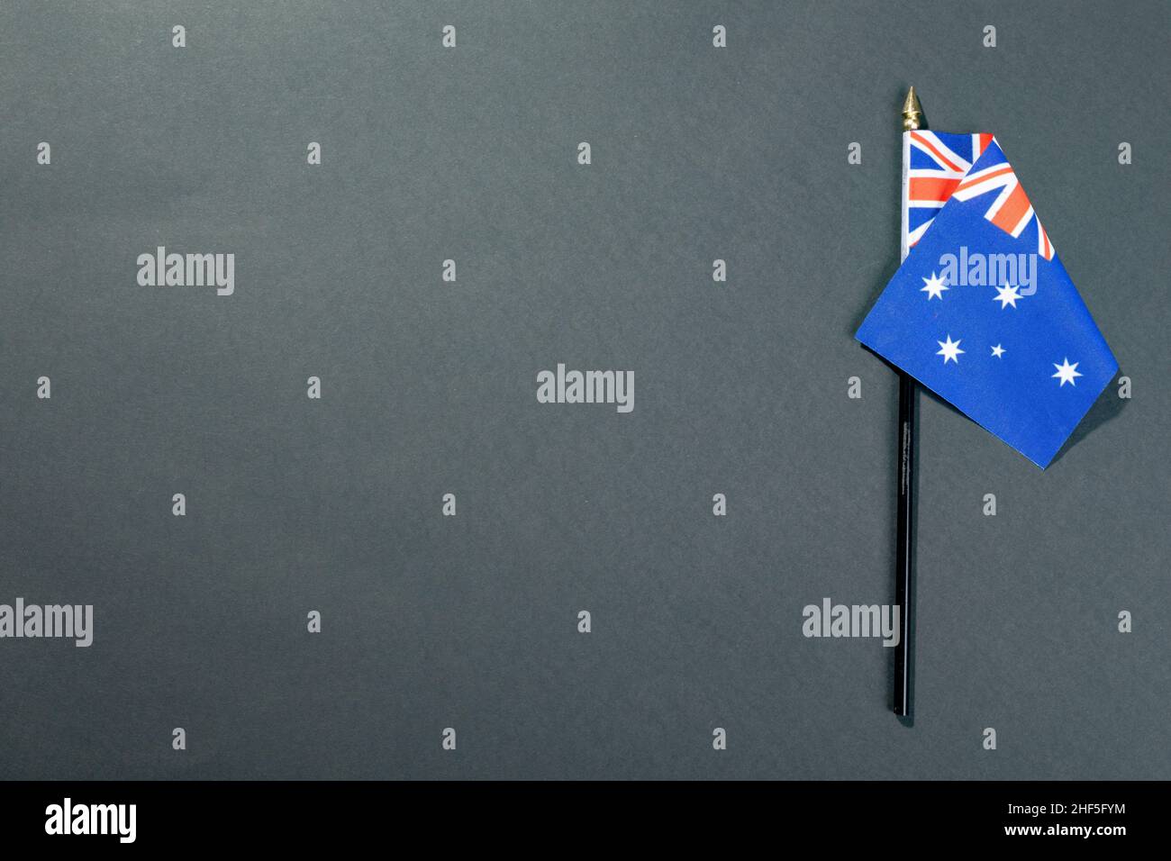 Stars and union jack on australia flag stick by copy space over black ...