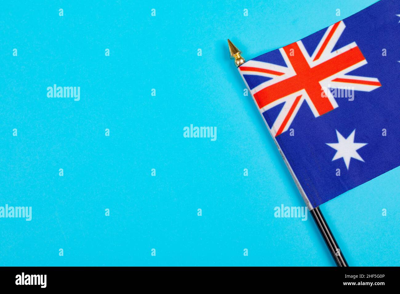 Star and union jack on australia flag stick by copy space over blue ...