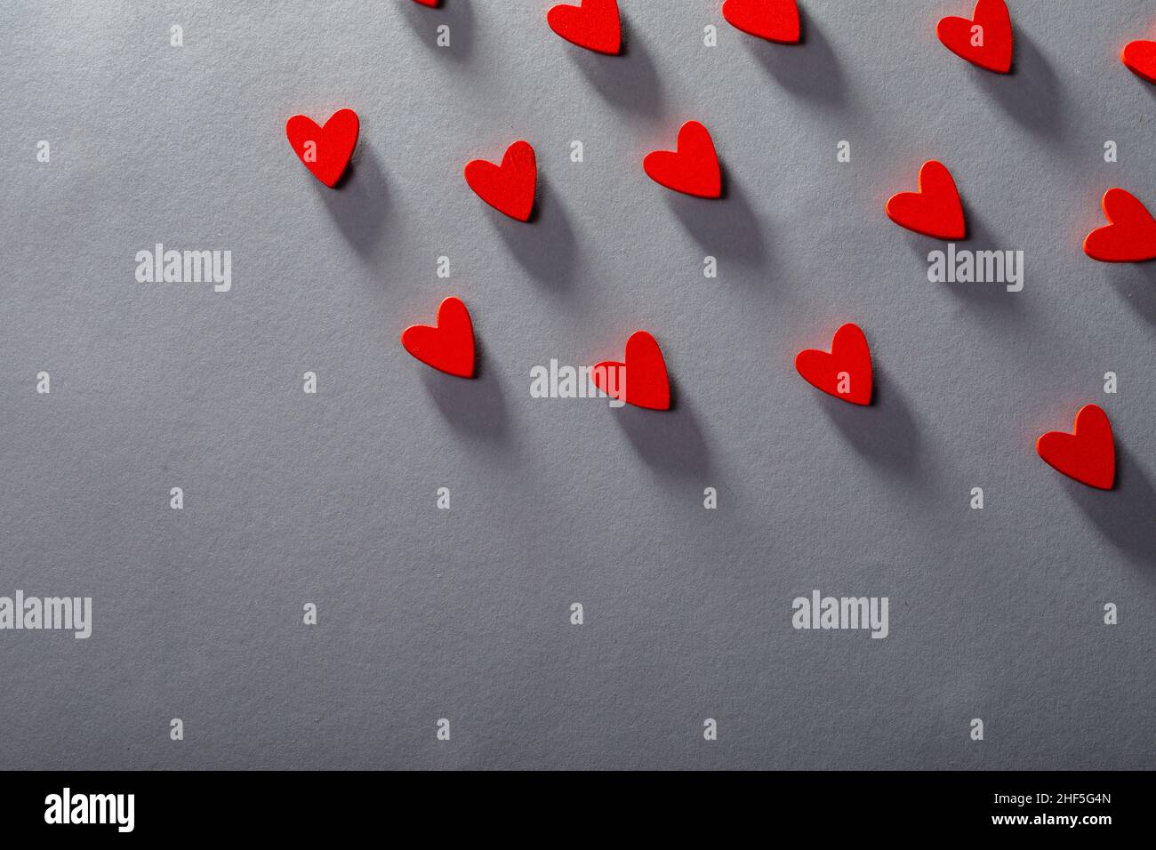 Overhead view of red heart shapes with shadows with copy space over ...