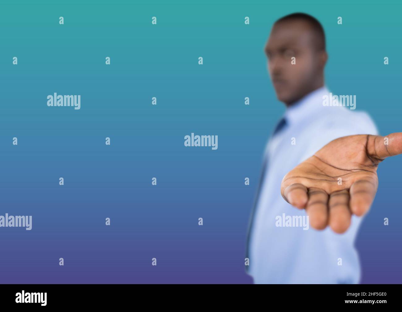 African american businessman with cupped hand with copy space on green ...