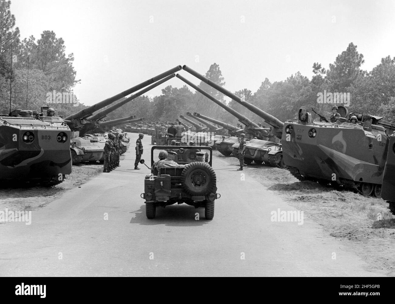 Secretary of Defense Caspar W. Weinberger is taken by jeep to inspect ...