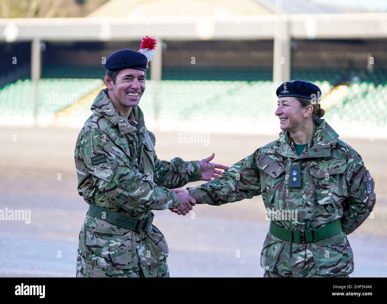 Lt Col Shamus Kelly shakes the hand of his wife, Lt Col Lyndsey Kelly ...