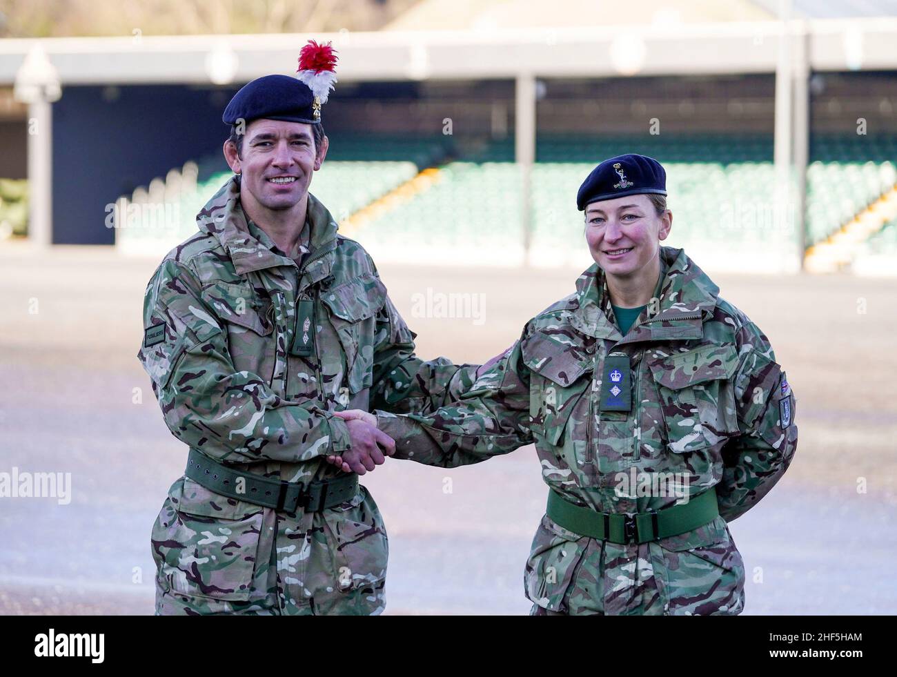 Lt Col Shamus Kelly shakes the hand of his wife, Lt Col Lyndsey Kelly ...