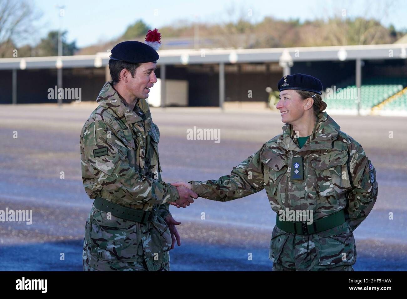 Lt Col Shamus Kelly shakes the hand of his wife, Lt Col Lyndsey Kelly ...