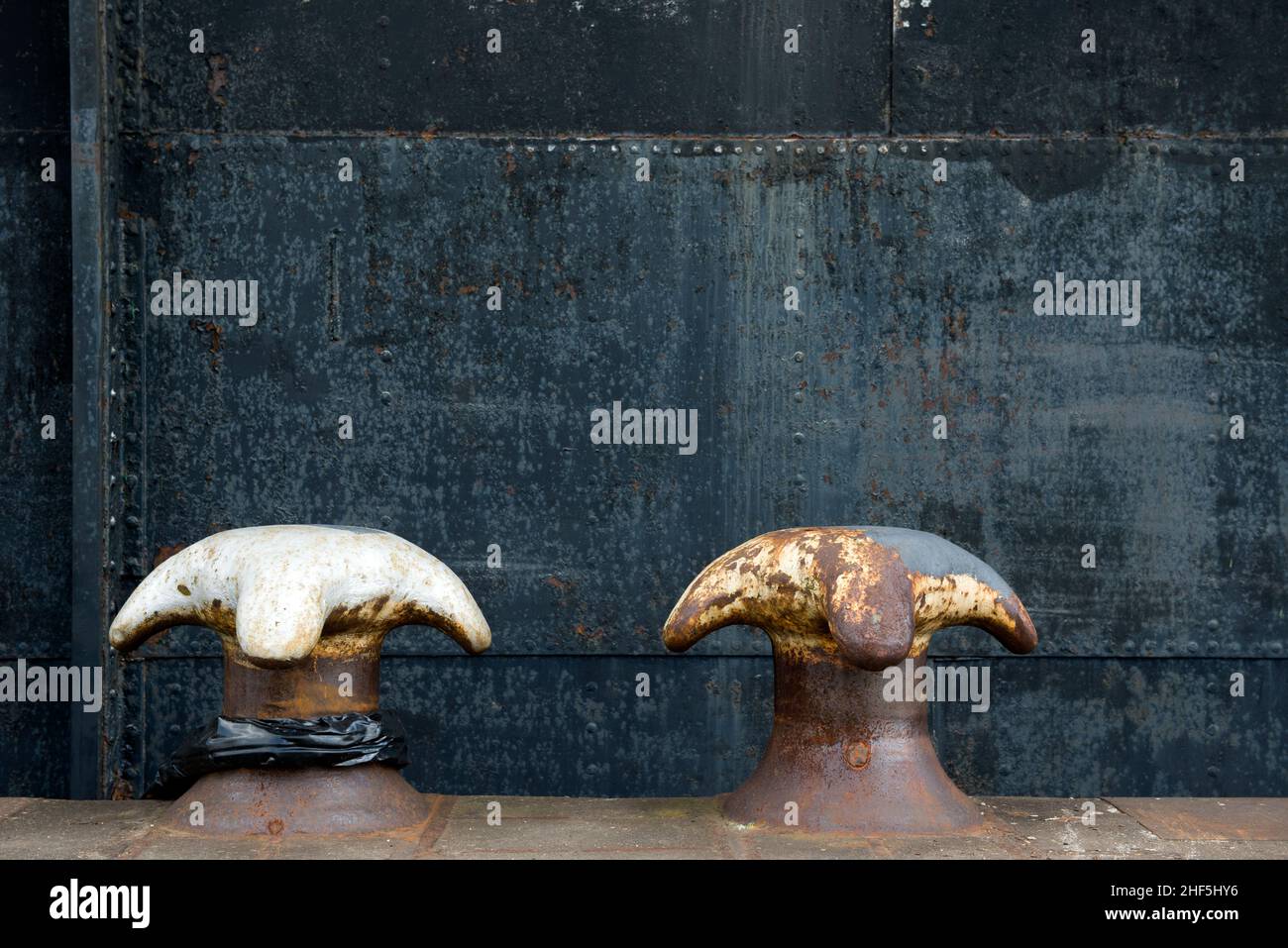 Rotterdam, Netherlands. Two bolders and mooring poles at a Merwehaven ...
