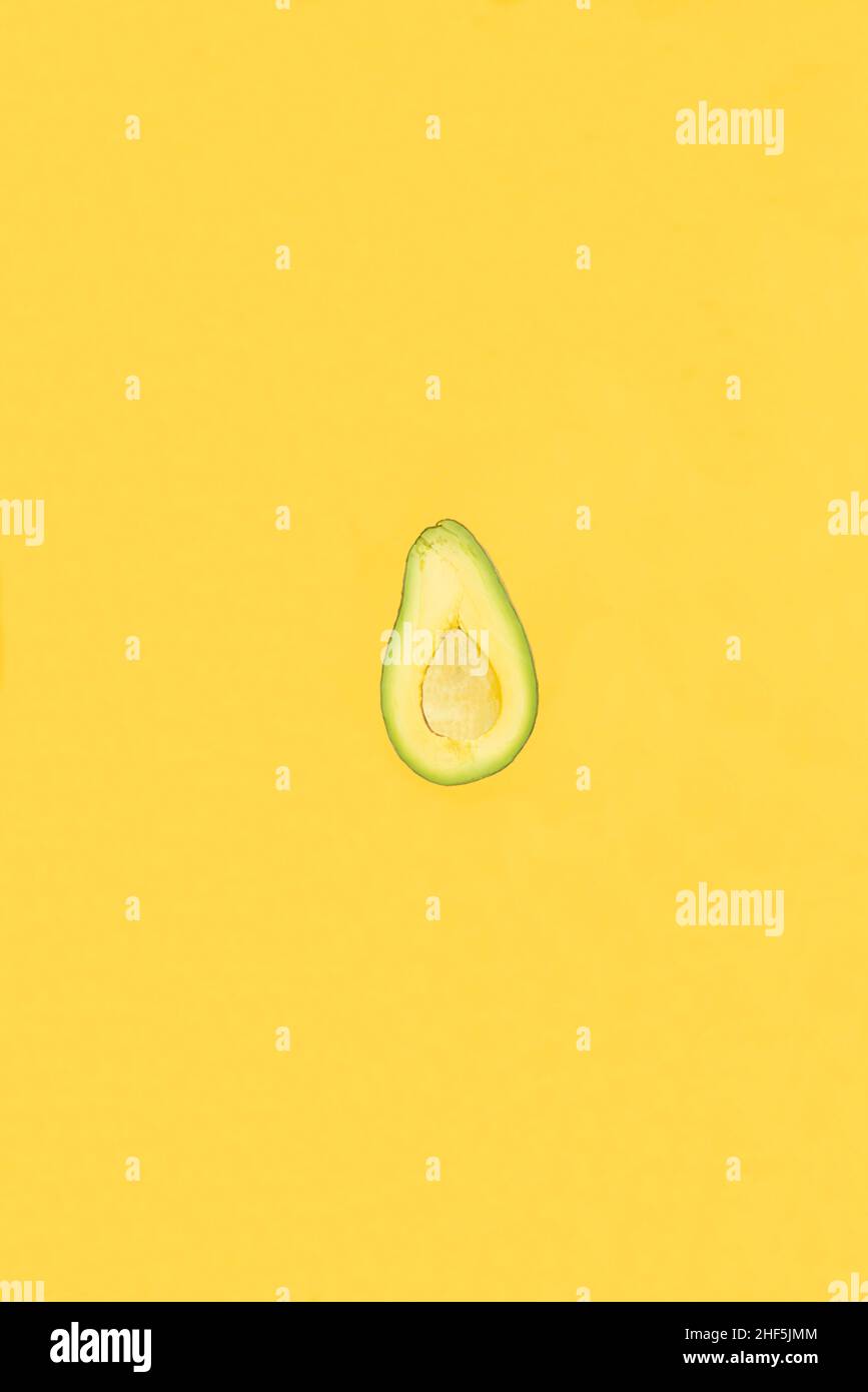 avocado fruit isolated in yellow background Stock Photo - Alamy