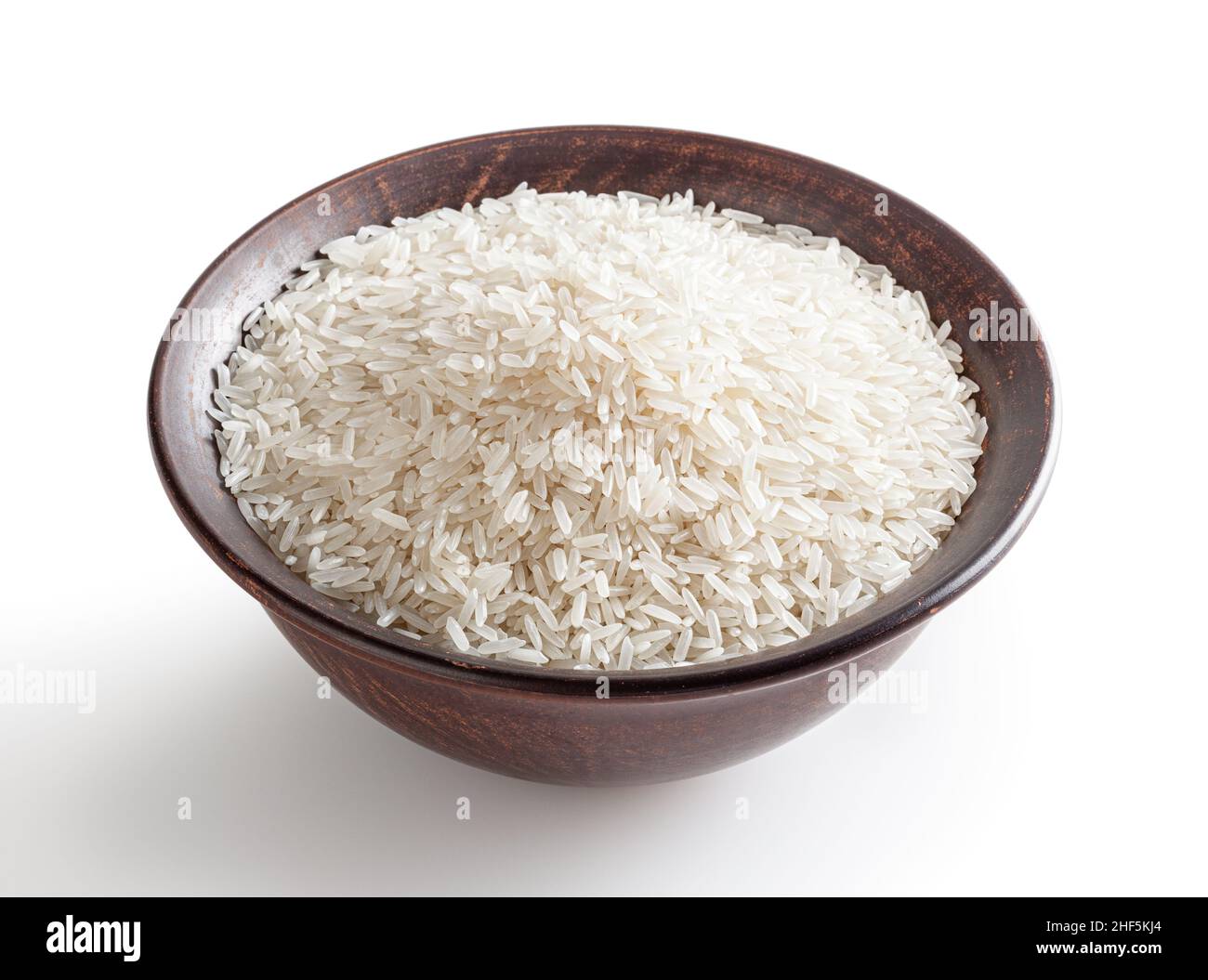 Uncooked jasmine rice in ceramic bowl isolated on white background with ...