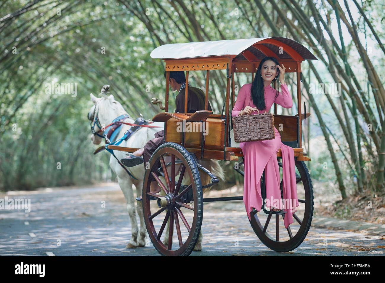 Ho Chi Minh city, Viet Nam: Vietnamese girls wear white ao dai and ride ...