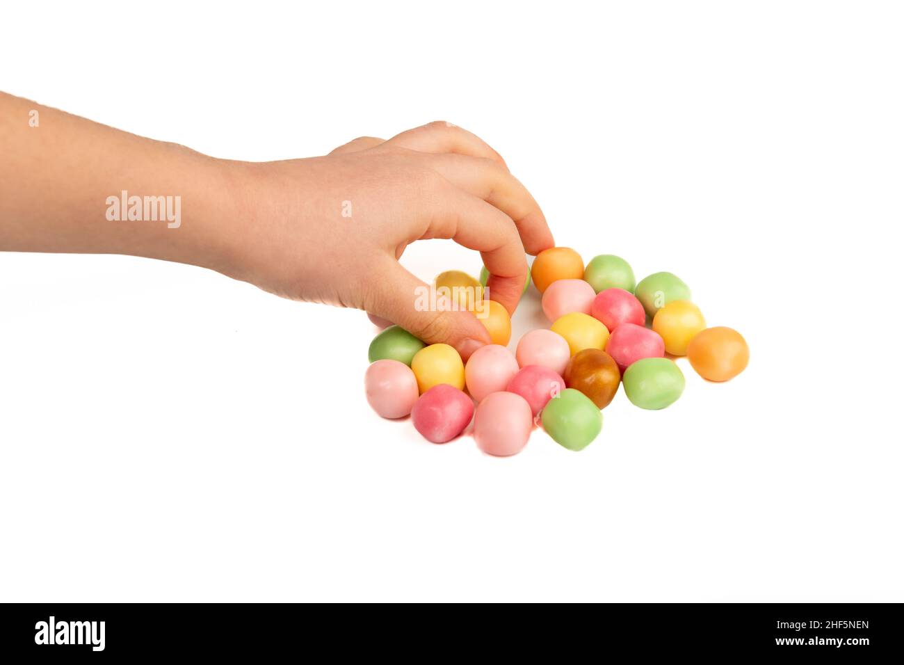 Child taking a candy on a white background Stock Photo - Alamy