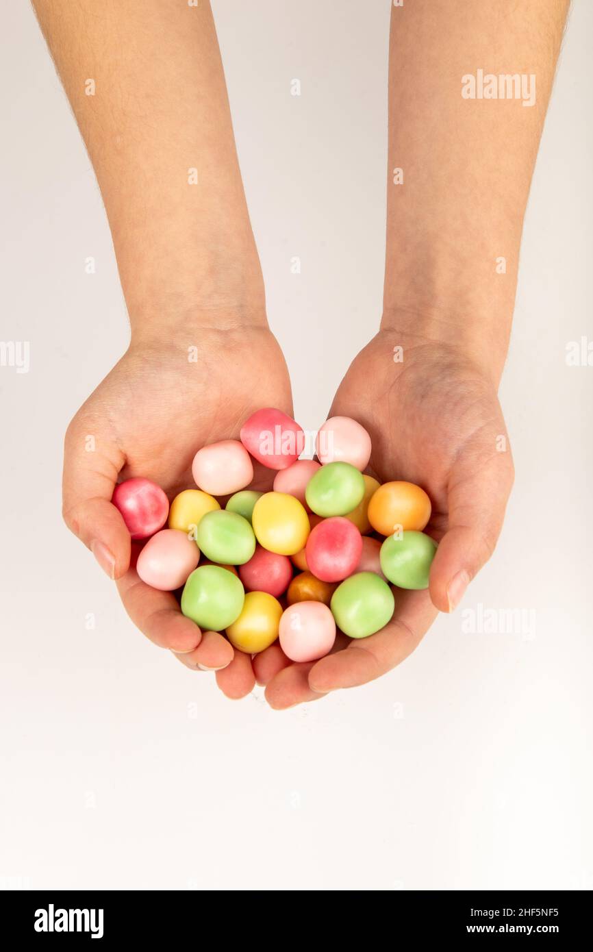 Child holding candy in his hands on white background Stock Photo - Alamy