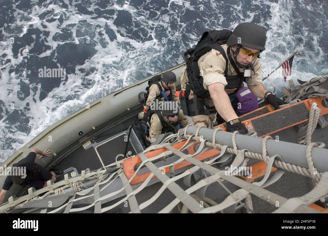 Search and seizure (VBSS) team member of USS Mustin, climbs the ship’s ...